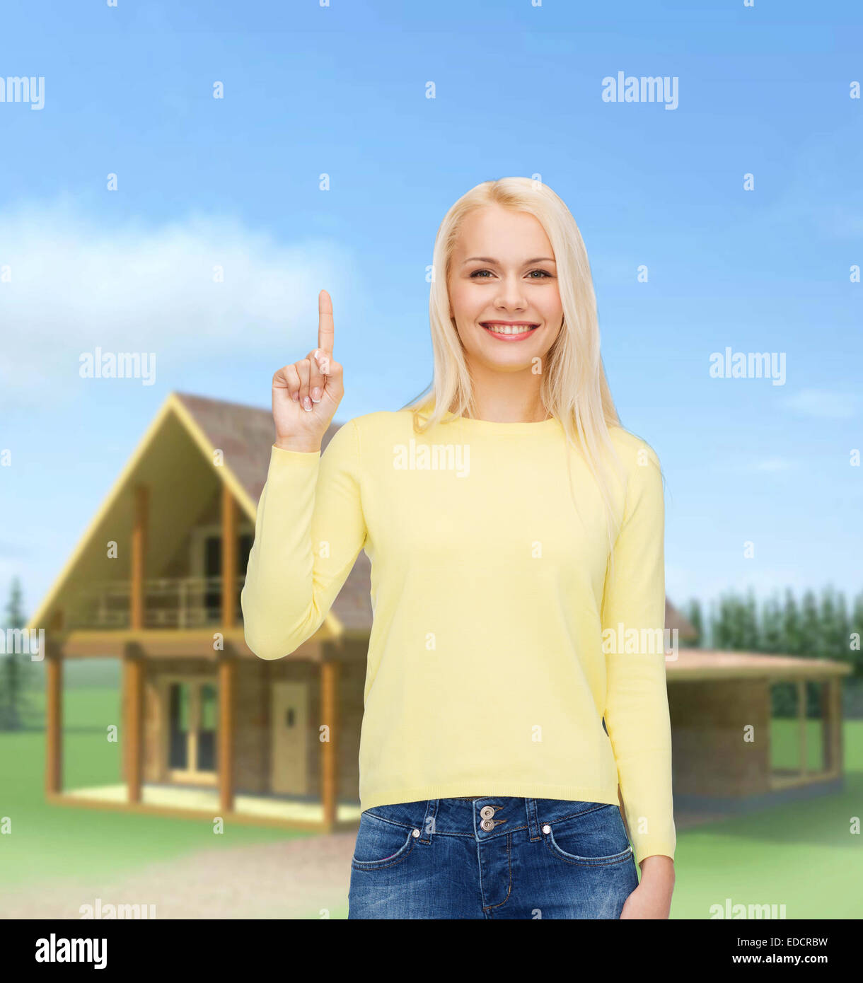 smiling woman pointing her finger up Stock Photo - Alamy