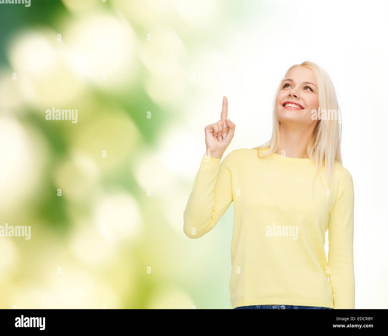 smiling woman pointing her finger up Stock Photo - Alamy