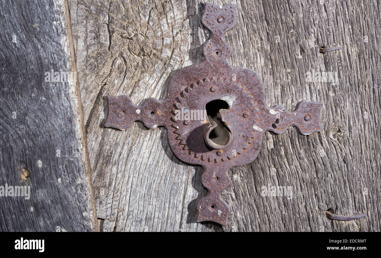 Old run-down wooden door and rusty iron lock Stock Photo - Alamy
