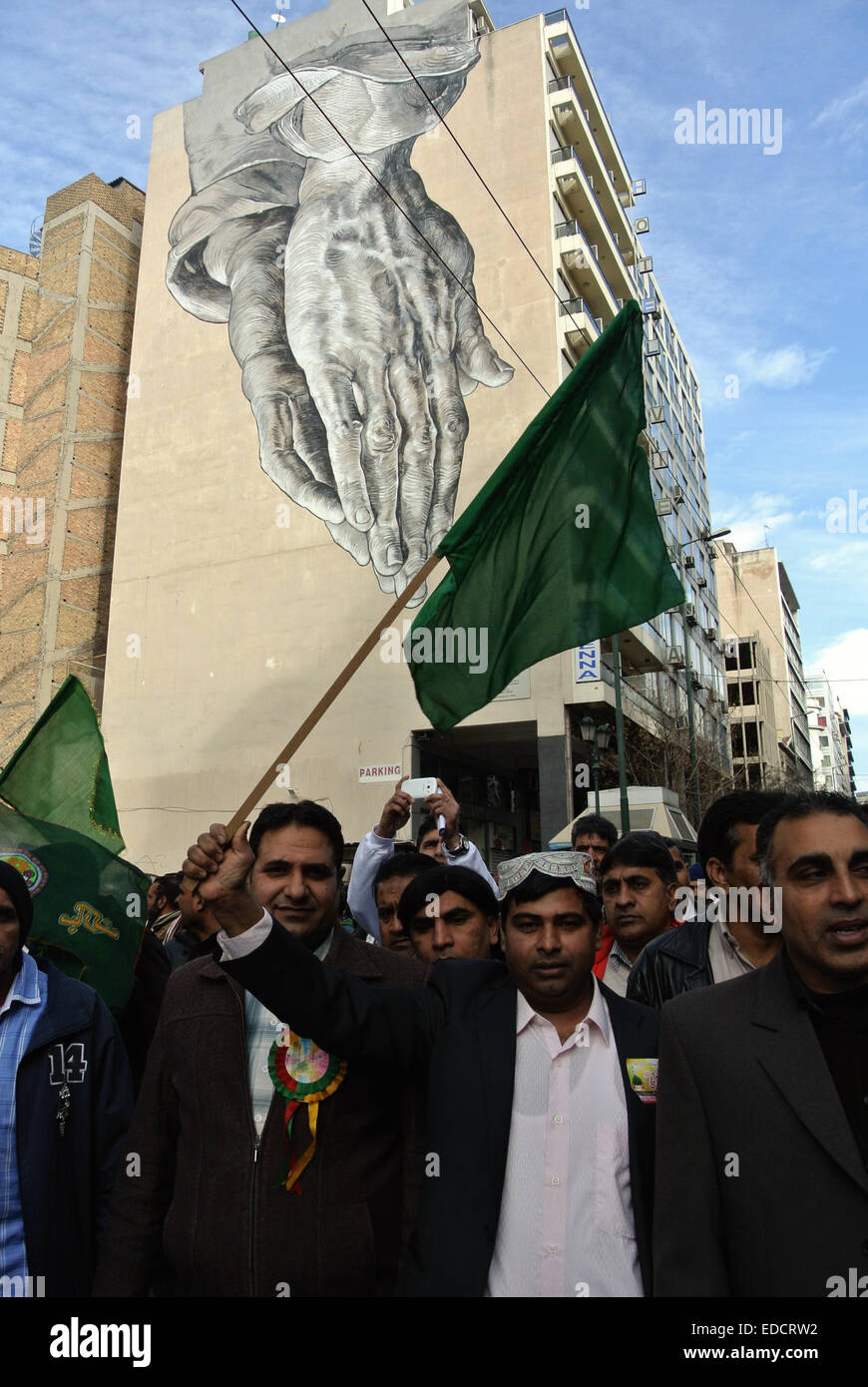A muslim holds a Greek Flag of Islam in the air.Muslims that live in ...