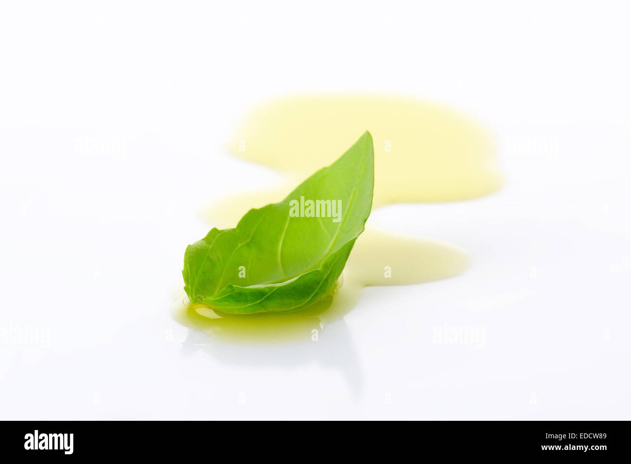 Olive oil drizzle and fresh basil leaf Stock Photo - Alamy