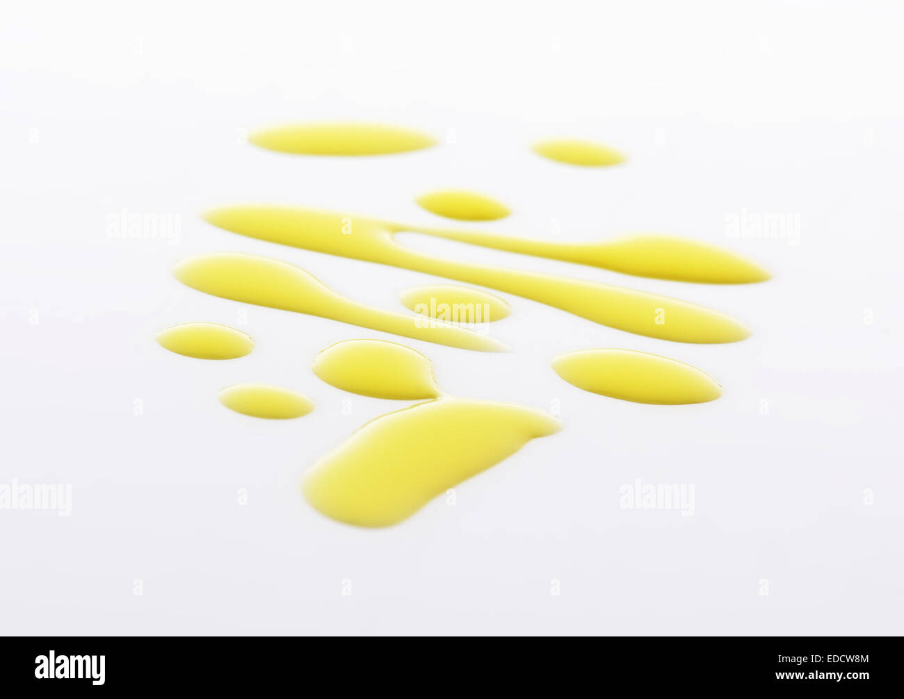 Olive oil drizzle on plain background Stock Photo - Alamy