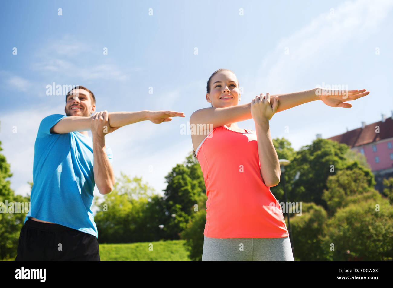 Sportive woman stretching hands outdoors hi-res stock photography and ...
