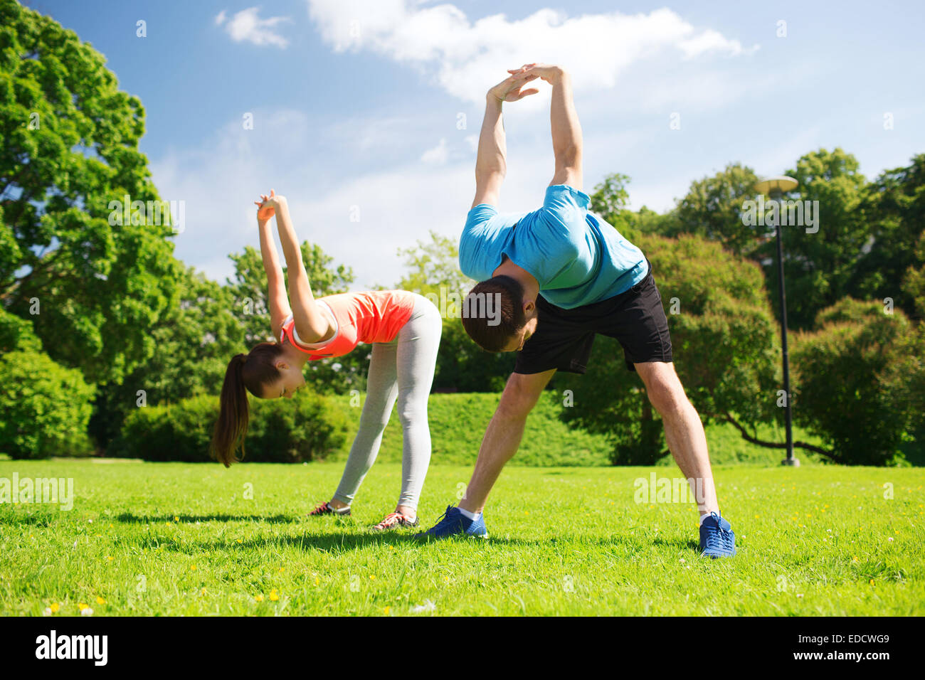 smiling couple stretching outdoors Stock Photo - Alamy