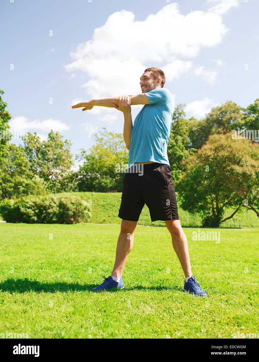 smiling man stretching outdoors Stock Photo - Alamy