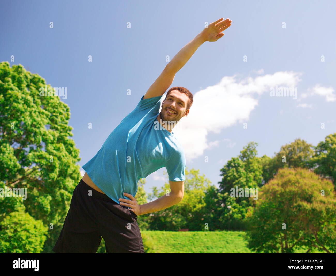smiling man stretching outdoors Stock Photo - Alamy