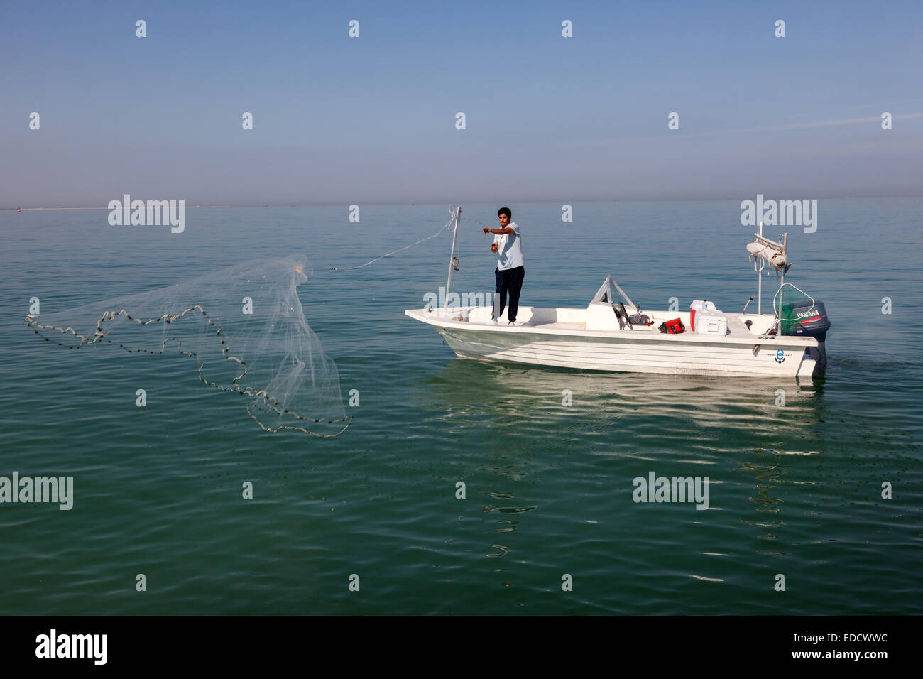 Arabic man fishes with the traditional net in the Gulf Stock Photo - Alamy