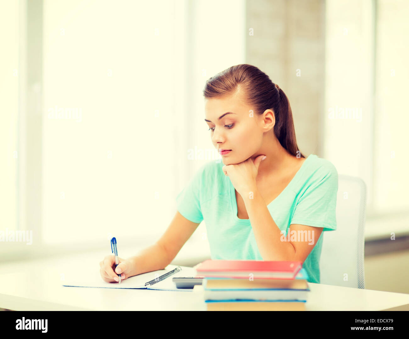 tired student writing in notebook Stock Photo - Alamy
