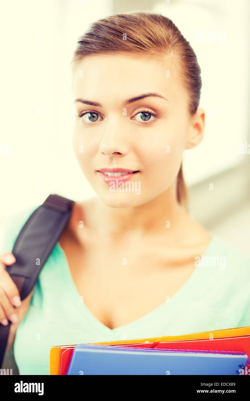 student girl with school bag and color folders Stock Photo - Alamy