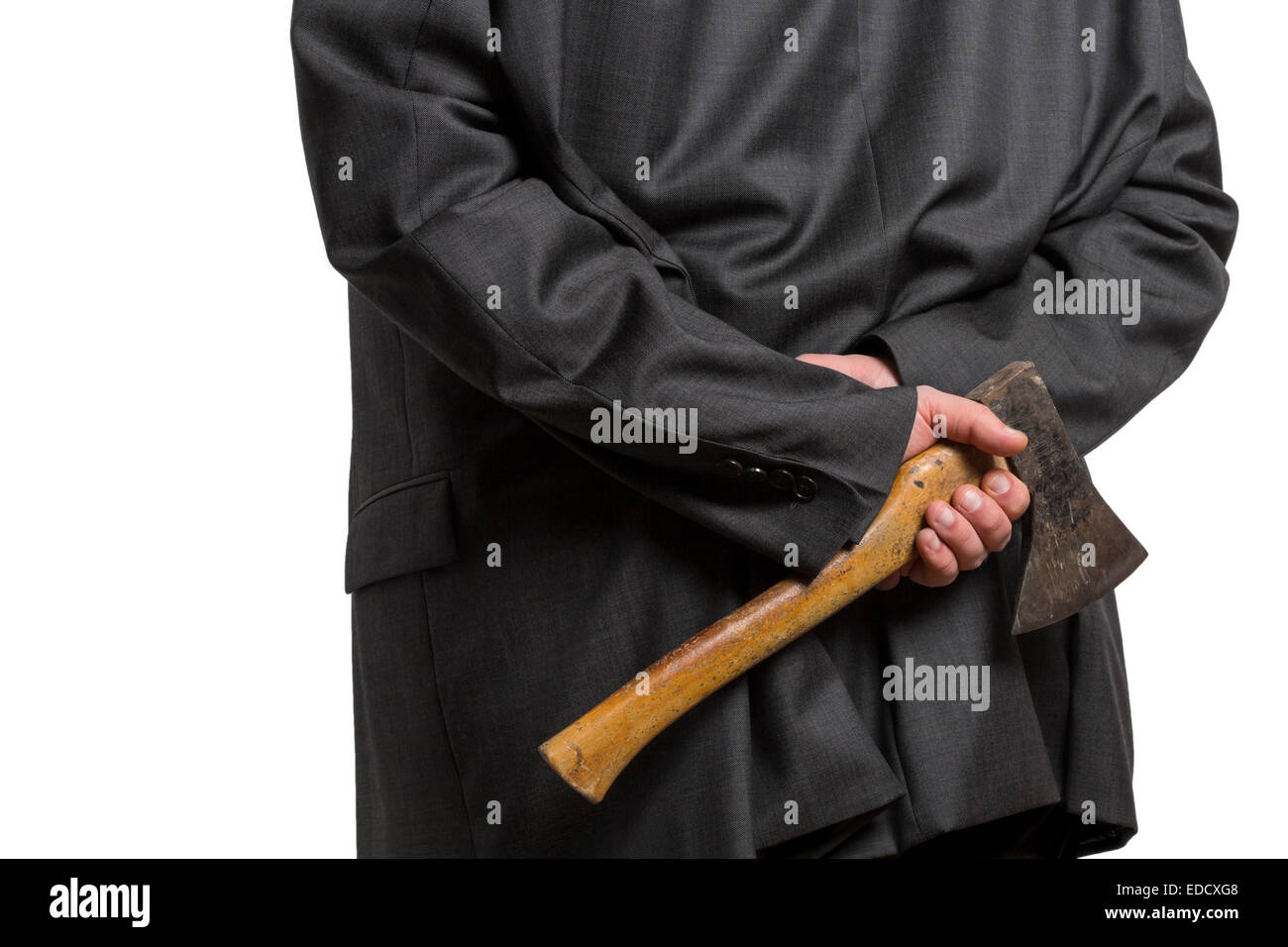 Man in suit hiding an axe behind his back isolated on white background ...