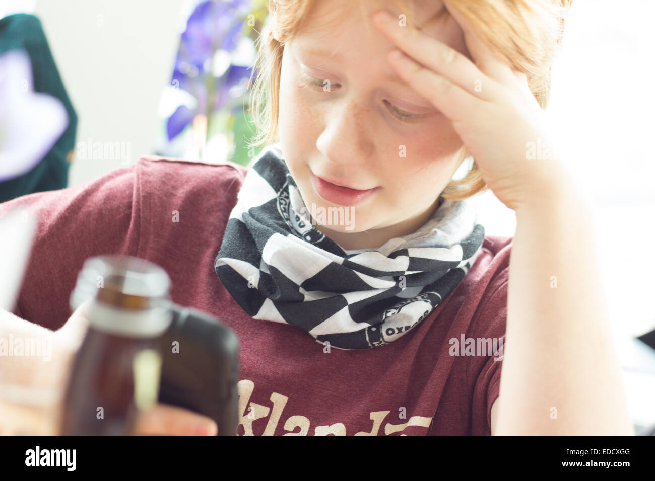 Boy playing iphone in refectory restaurant Stock Photo - Alamy