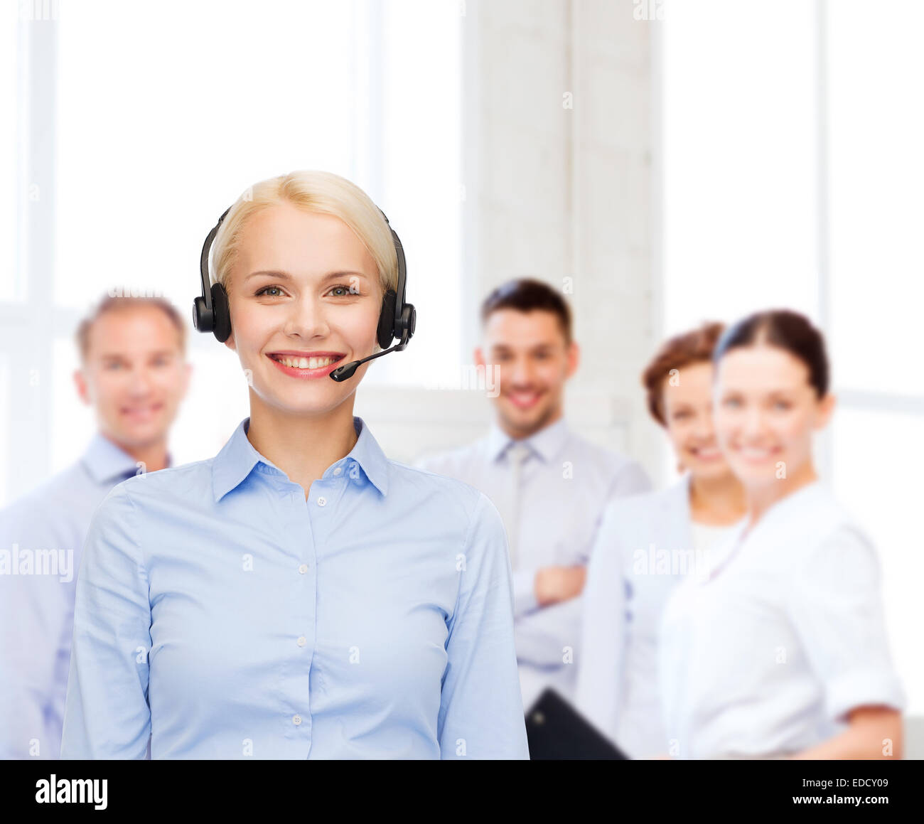 friendly female helpline operator with headphones Stock Photo - Alamy