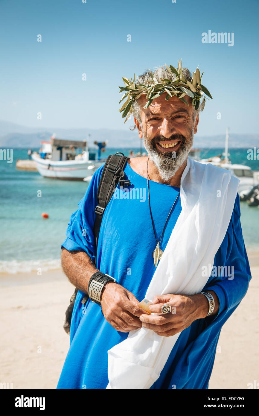 A happy greek man wearing traditional clothing and laurel wreath on a ...