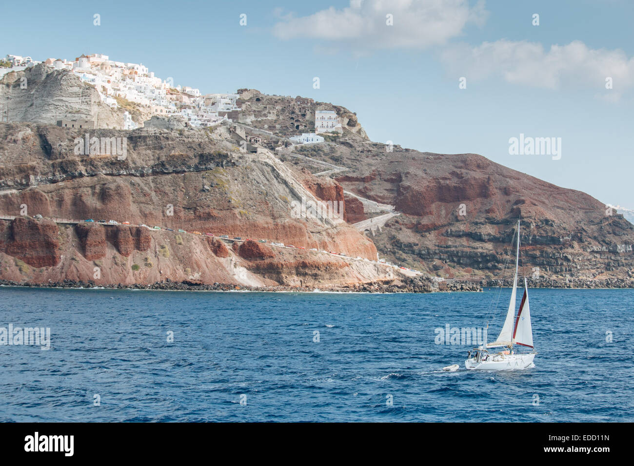 A view of Santorini with a sail boat, Cyclades, Greek islands, Greece ...