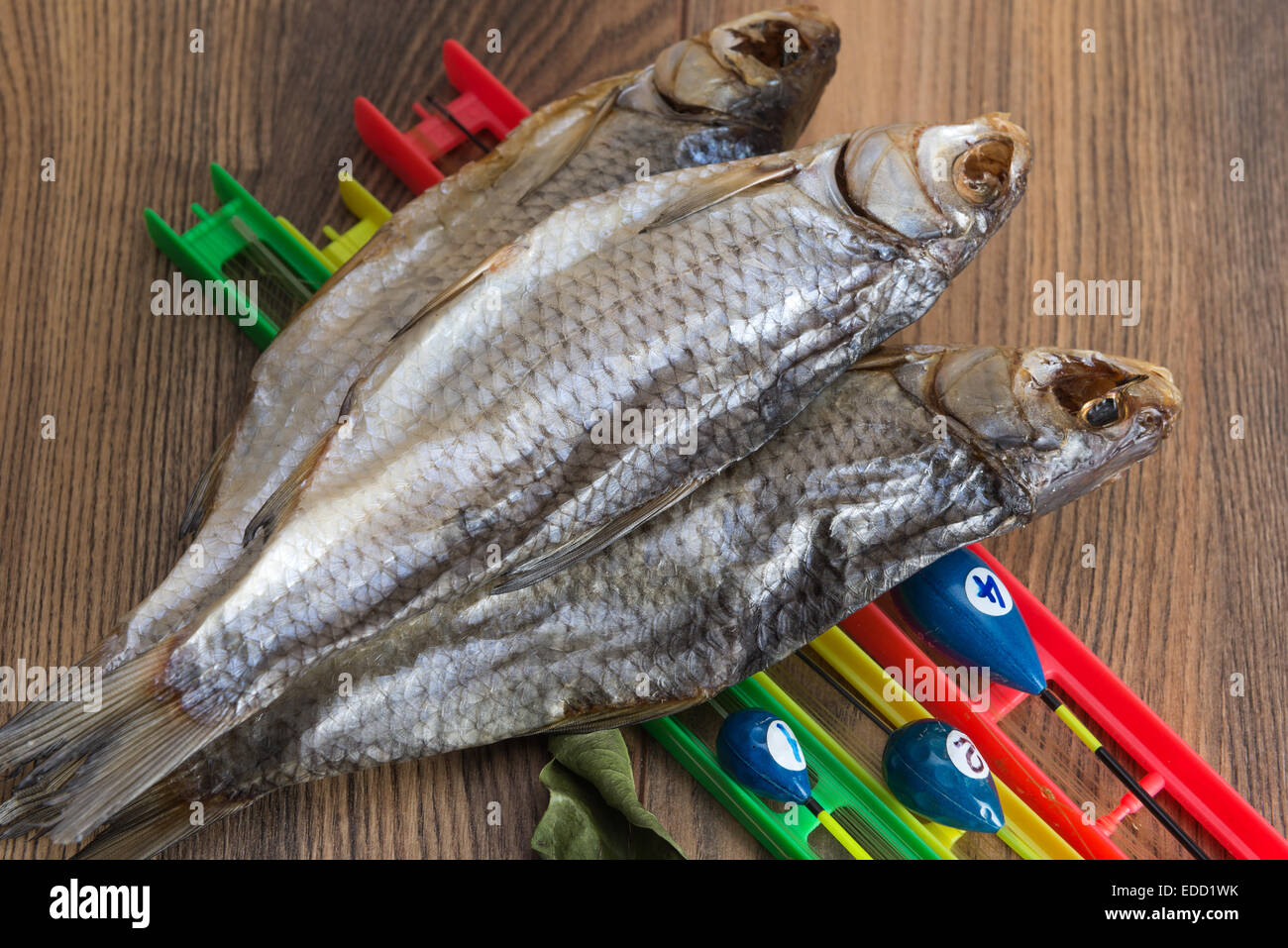 Dried roach - vobla and fishing equipment with a float on a wooden ...