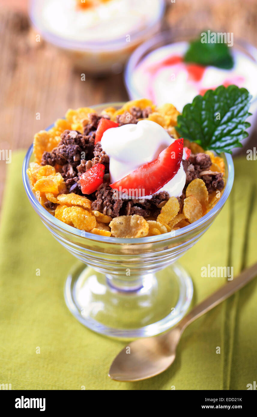 Breakfast cereals and two bowls of white yogurt with jam Stock Photo ...