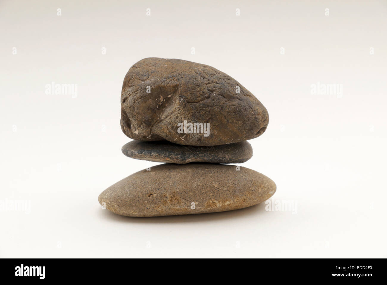River rocks balanced on a white background Stock Photo - Alamy