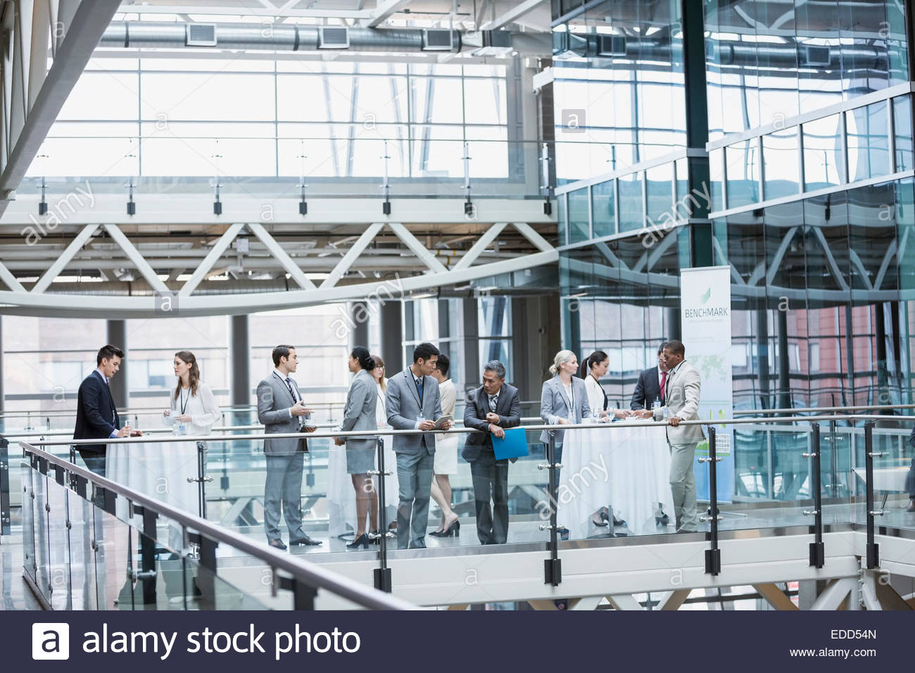 Business people networking at tables in atrium Stock Photo - Alamy