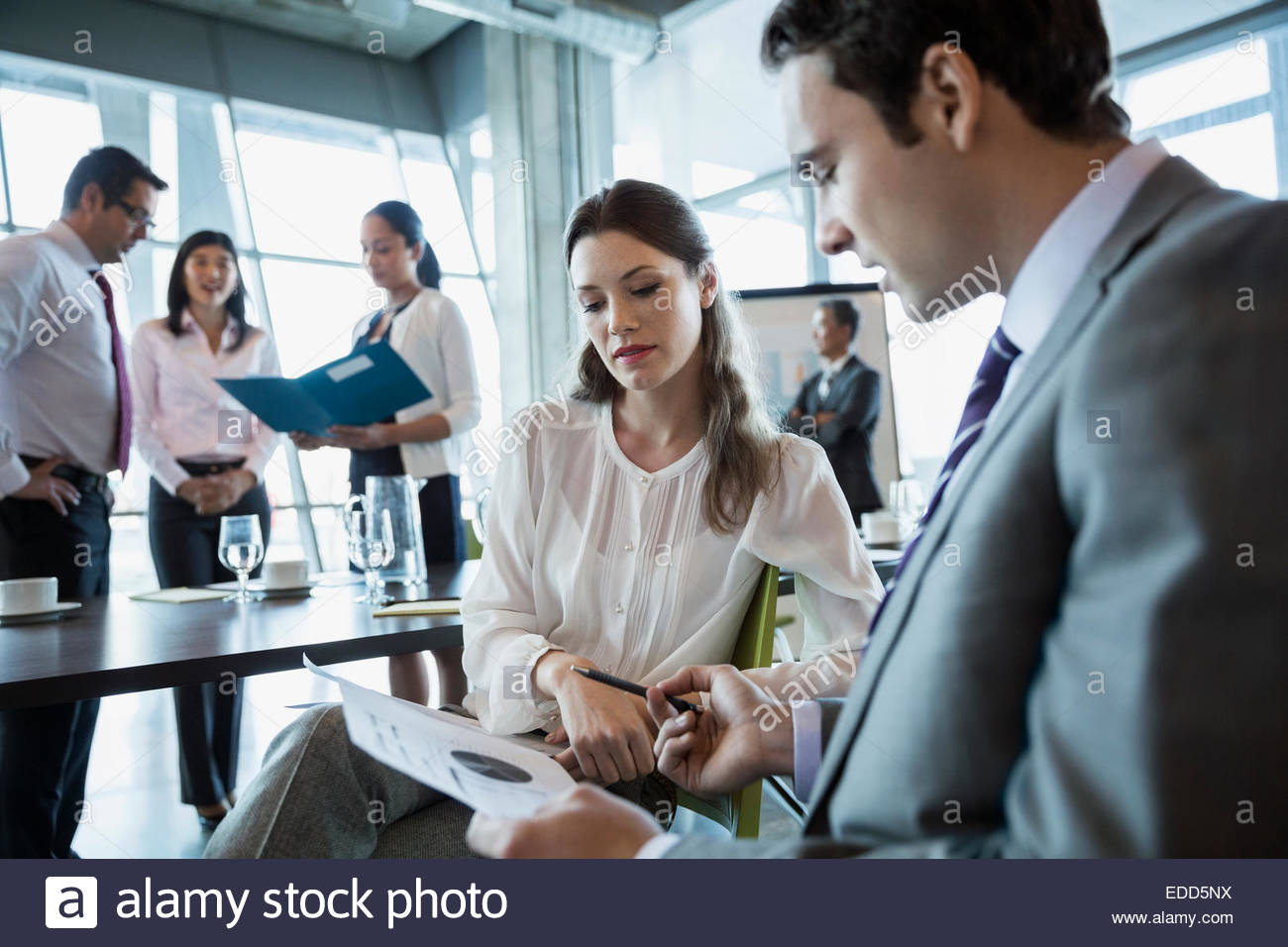 Business people reviewing data in conference room meeting Stock Photo ...