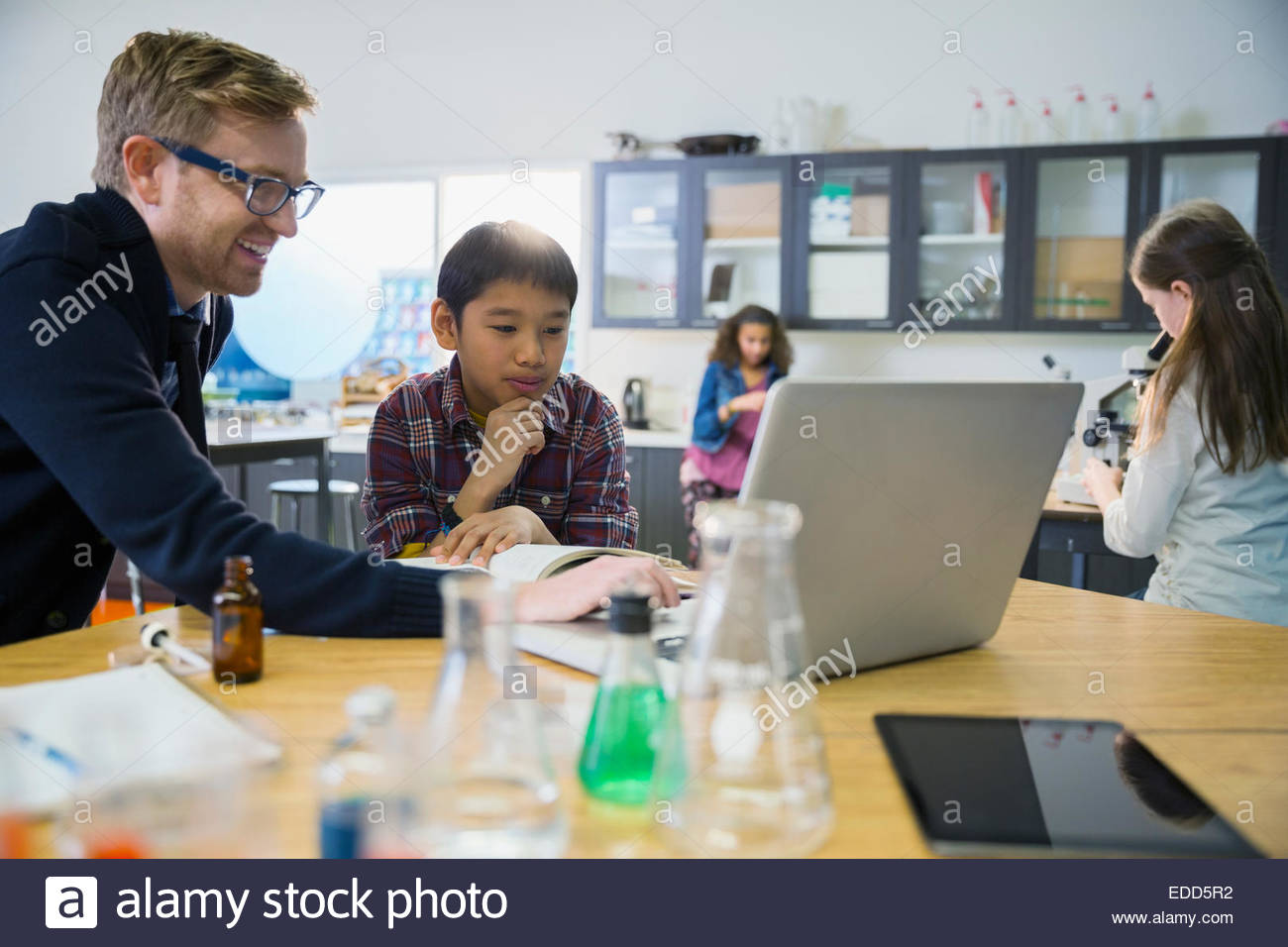 Child typing laptop in classroom hi-res stock photography and images ...
