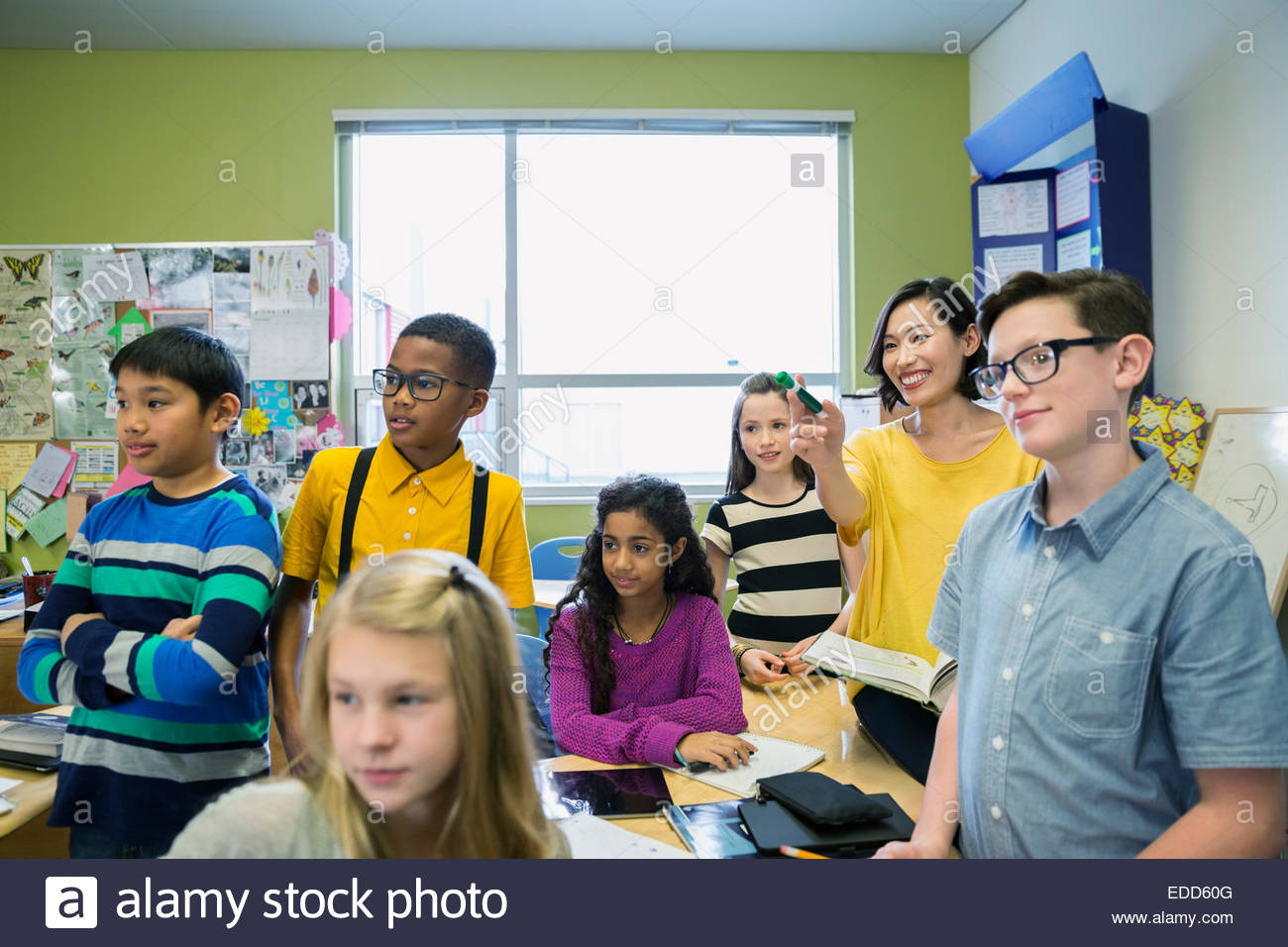 Teacher and elementary students in classroom Stock Photo - Alamy