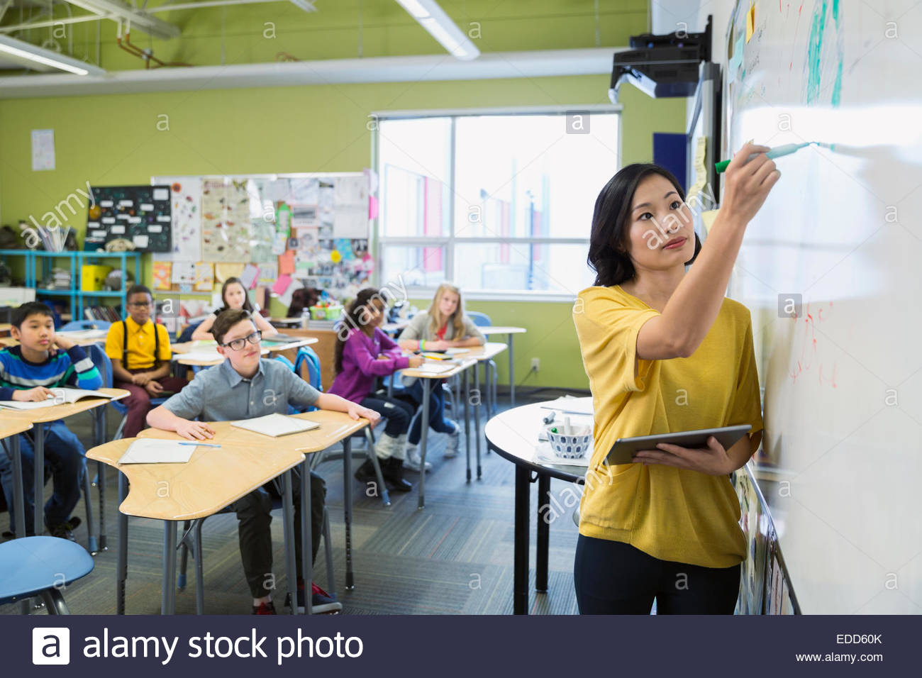 Teacher writing on whiteboard hi-res stock photography and images - Alamy