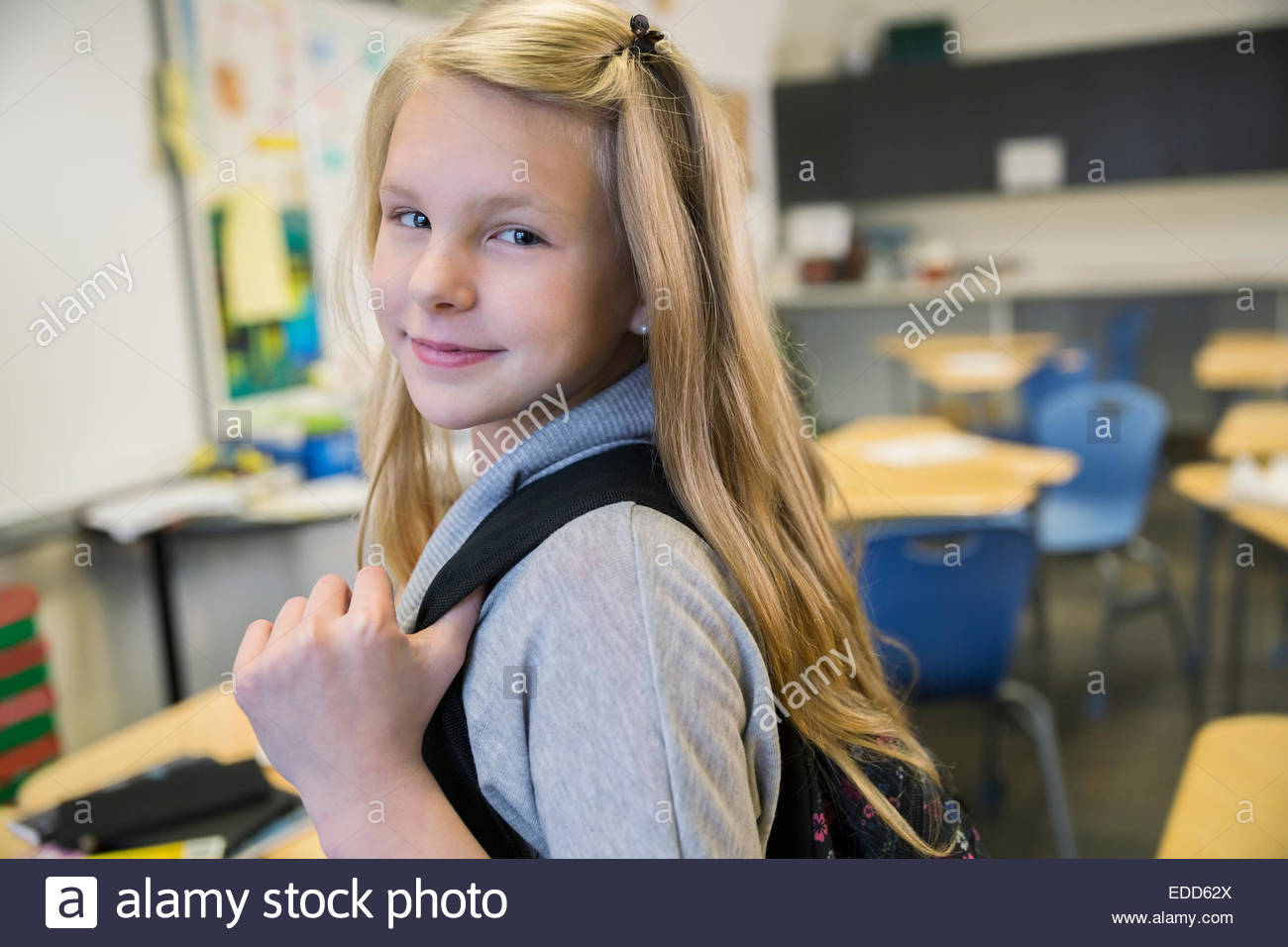 Portrait of confident elementary student in classroom Stock Photo - Alamy
