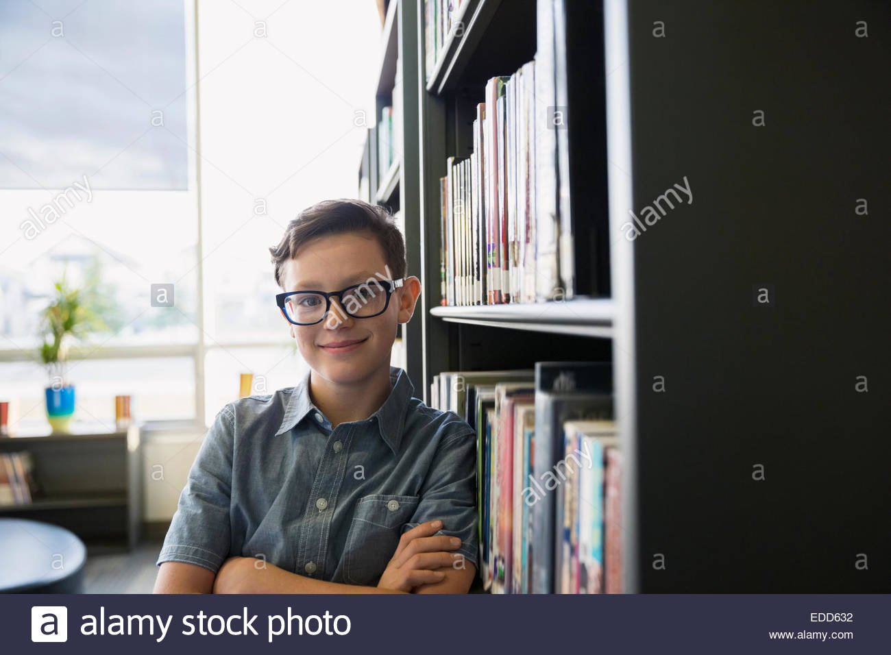 Portrait of confident elementary student in library Stock Photo - Alamy