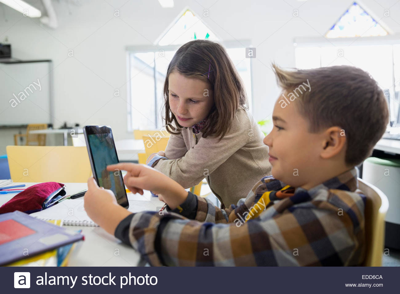 Boy girl classroom showing book hi-res stock photography and images - Alamy