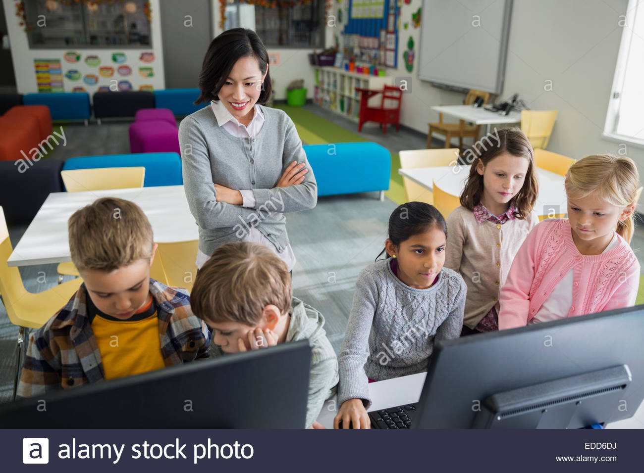 Standing watching arms crossed learning hi-res stock photography and ...