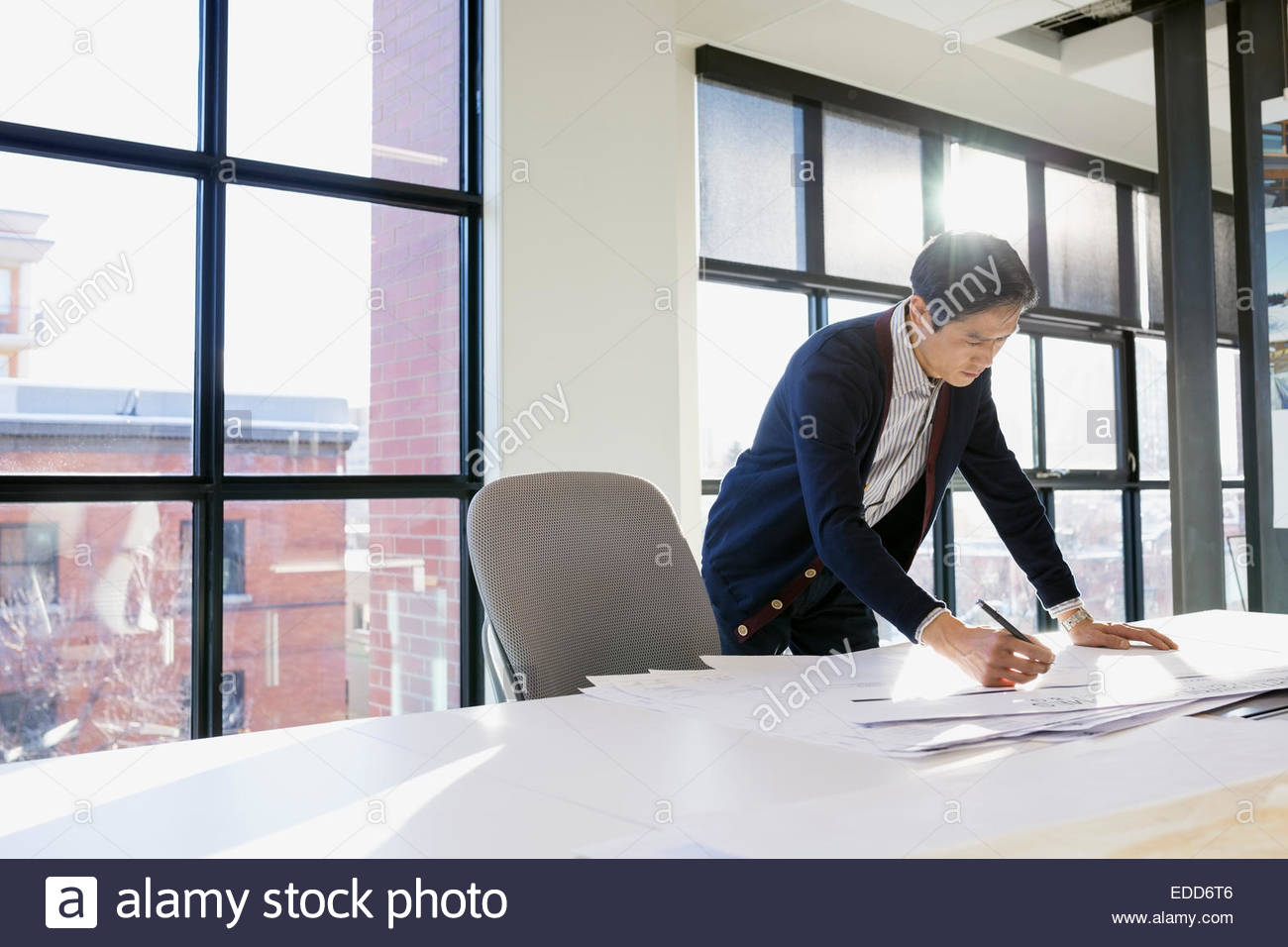 Architect drafting blueprints in office Stock Photo - Alamy