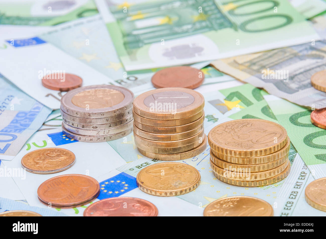 Euro banknotes and euro coins in simple example of unpredictable ...