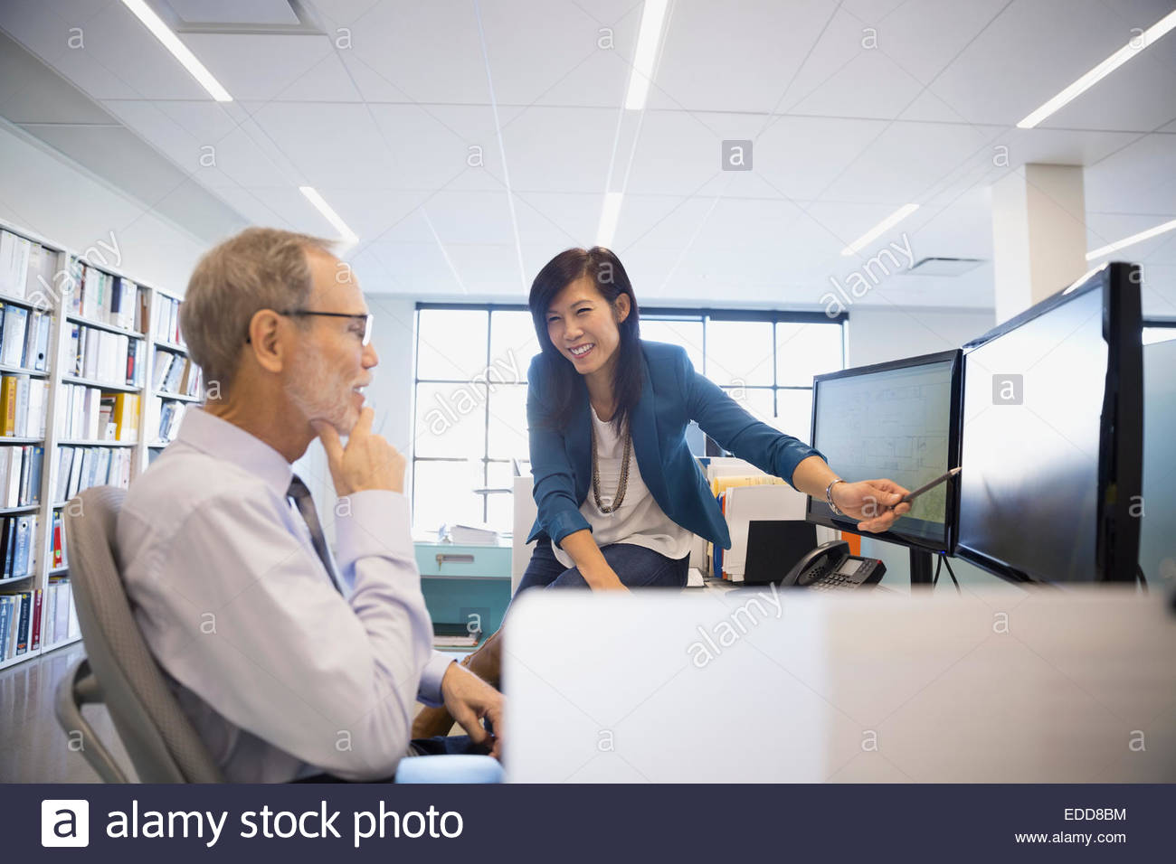 Business people working at computers in office Stock Photo - Alamy