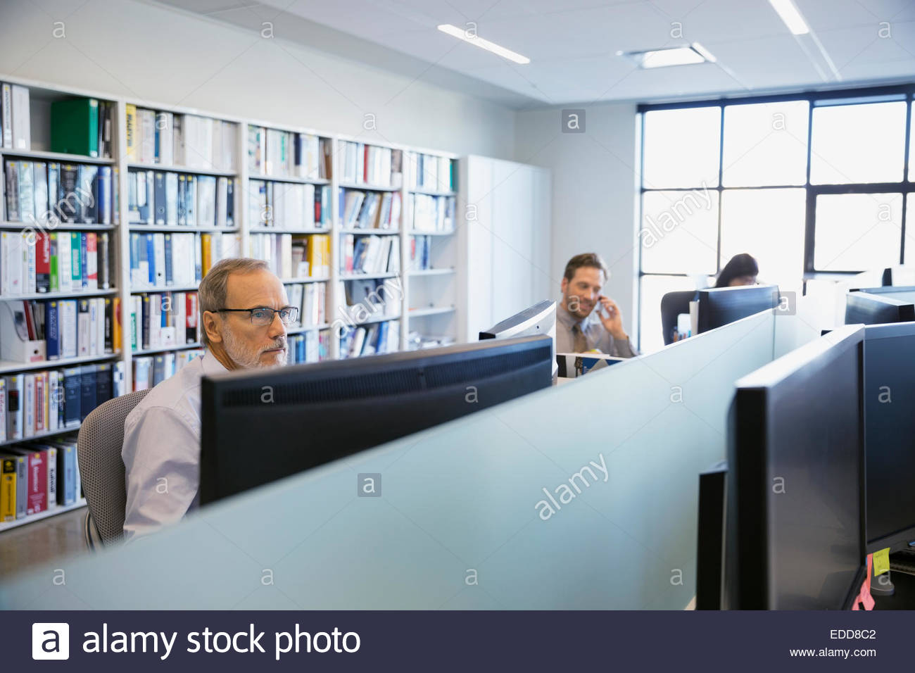 People sitting computers working office hi-res stock photography and ...