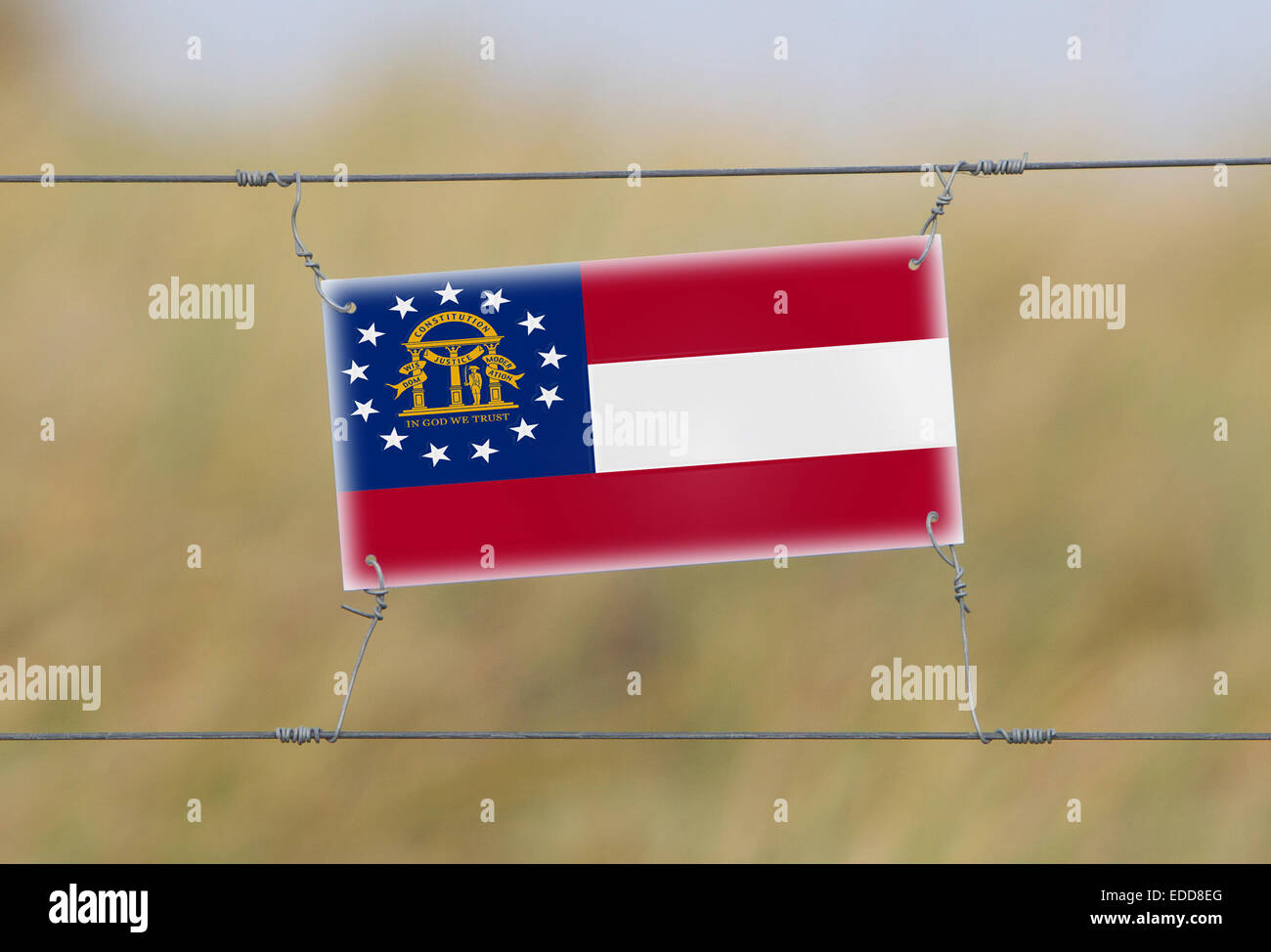 Border fence - Old plastic sign with a flag - Georgia Stock Photo - Alamy