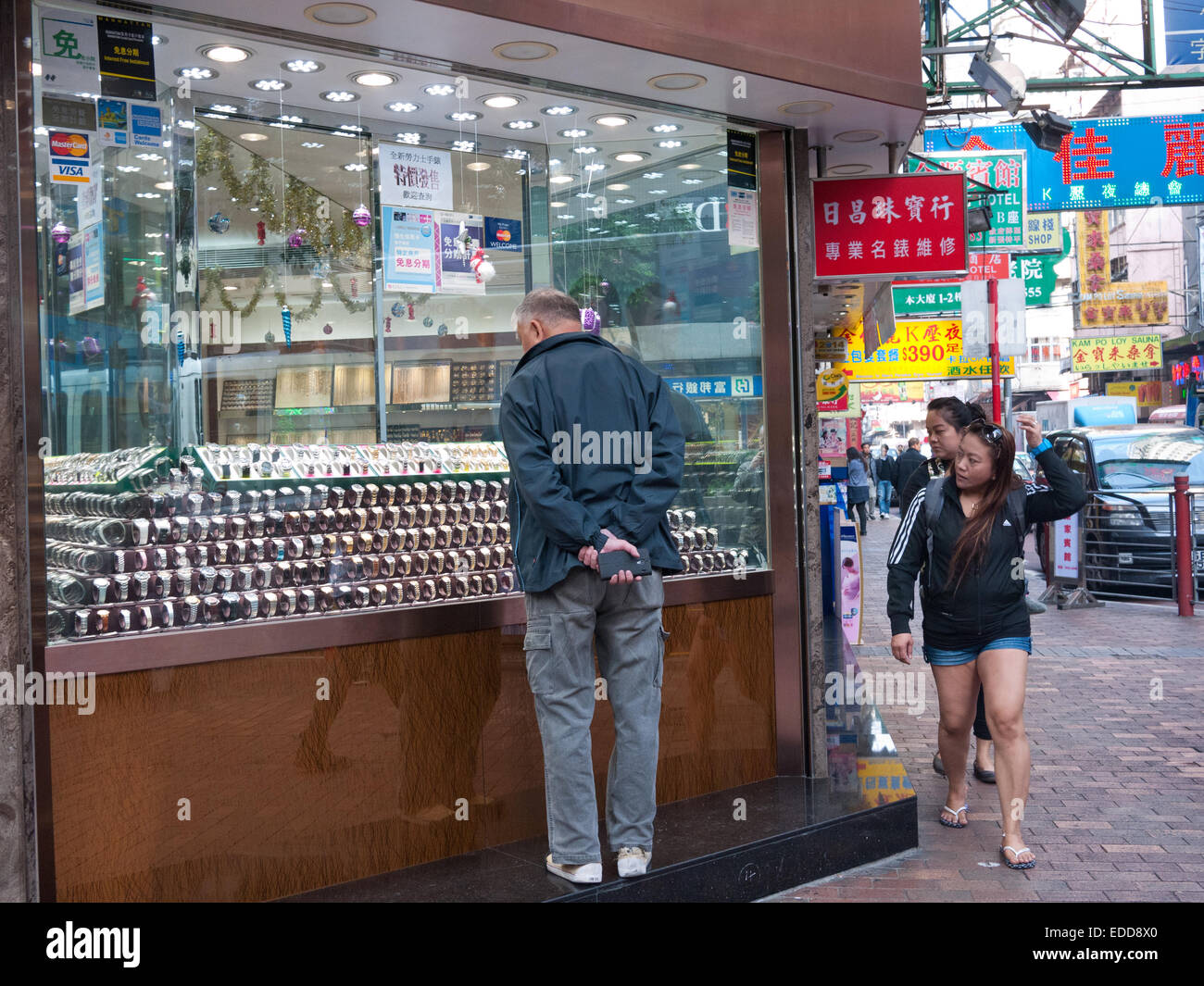 Hong Kong - Man looking at watch shop window Stock Photo - Alamy
