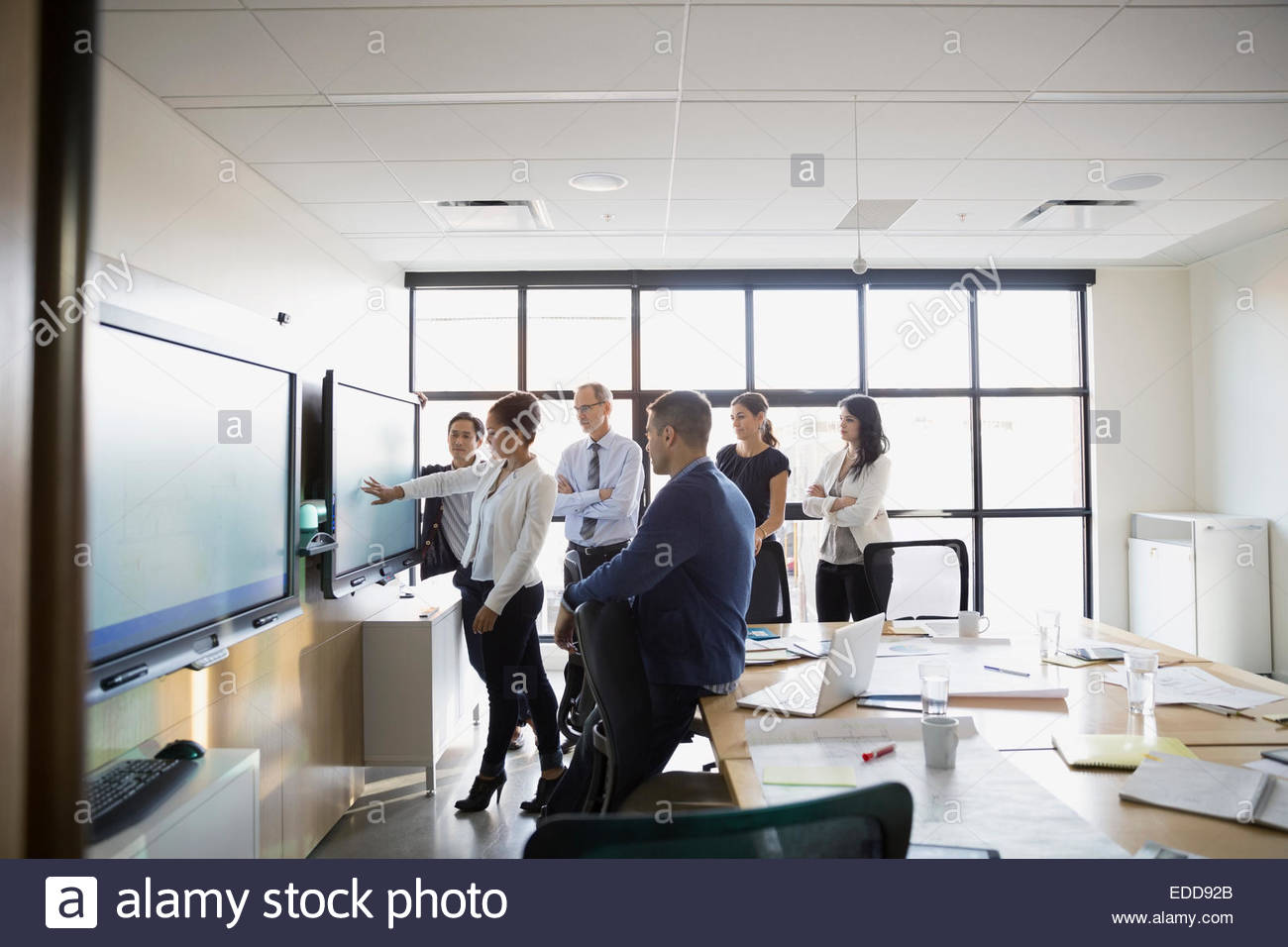 Business people pointing at monitor hi-res stock photography and images ...