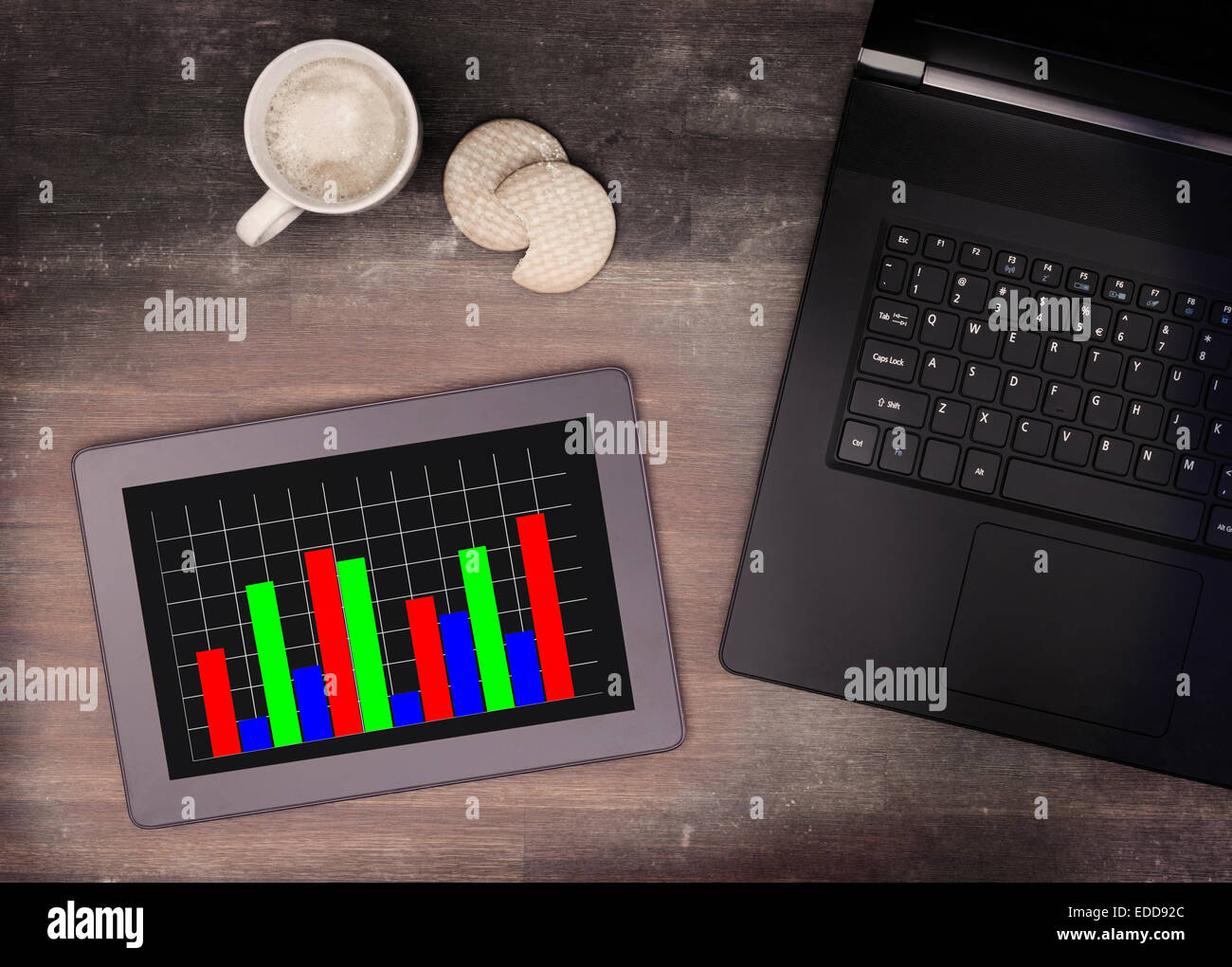 Tablet touch computer gadget on wooden table, graph, vintage look Stock ...