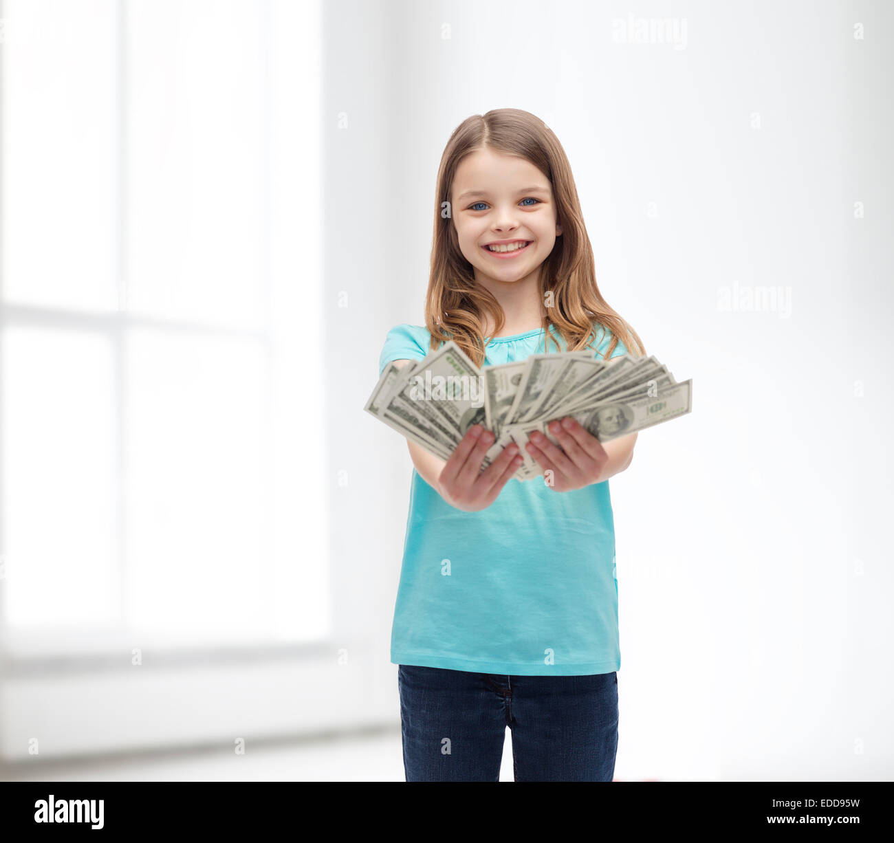 smiling little girl giving dollar cash money Stock Photo - Alamy