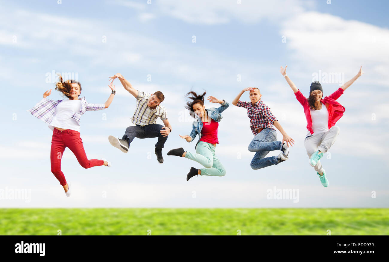 group of teenagers jumping Stock Photo - Alamy
