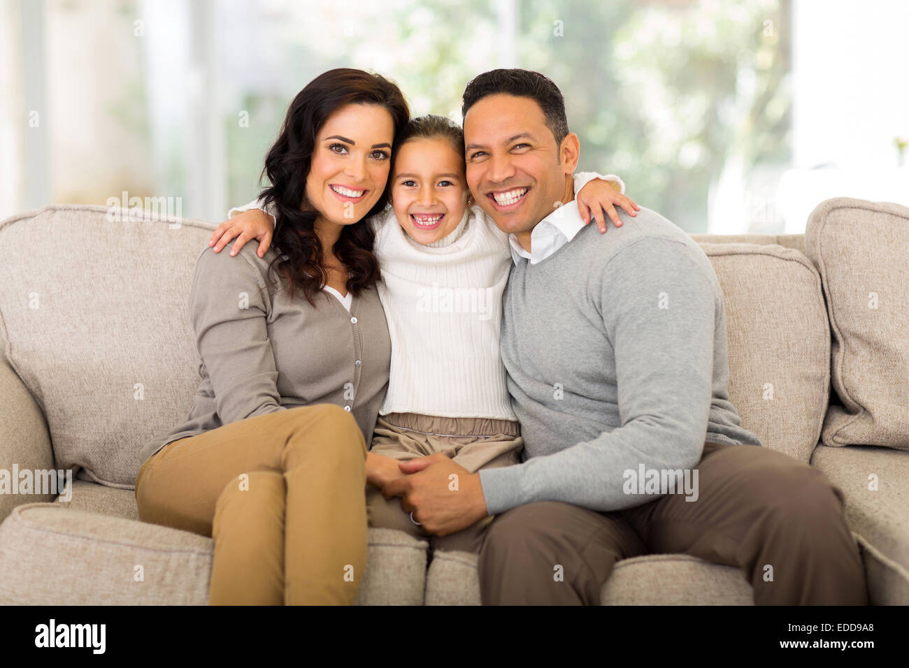 Family sitting on the couch hi-res stock photography and images - Alamy