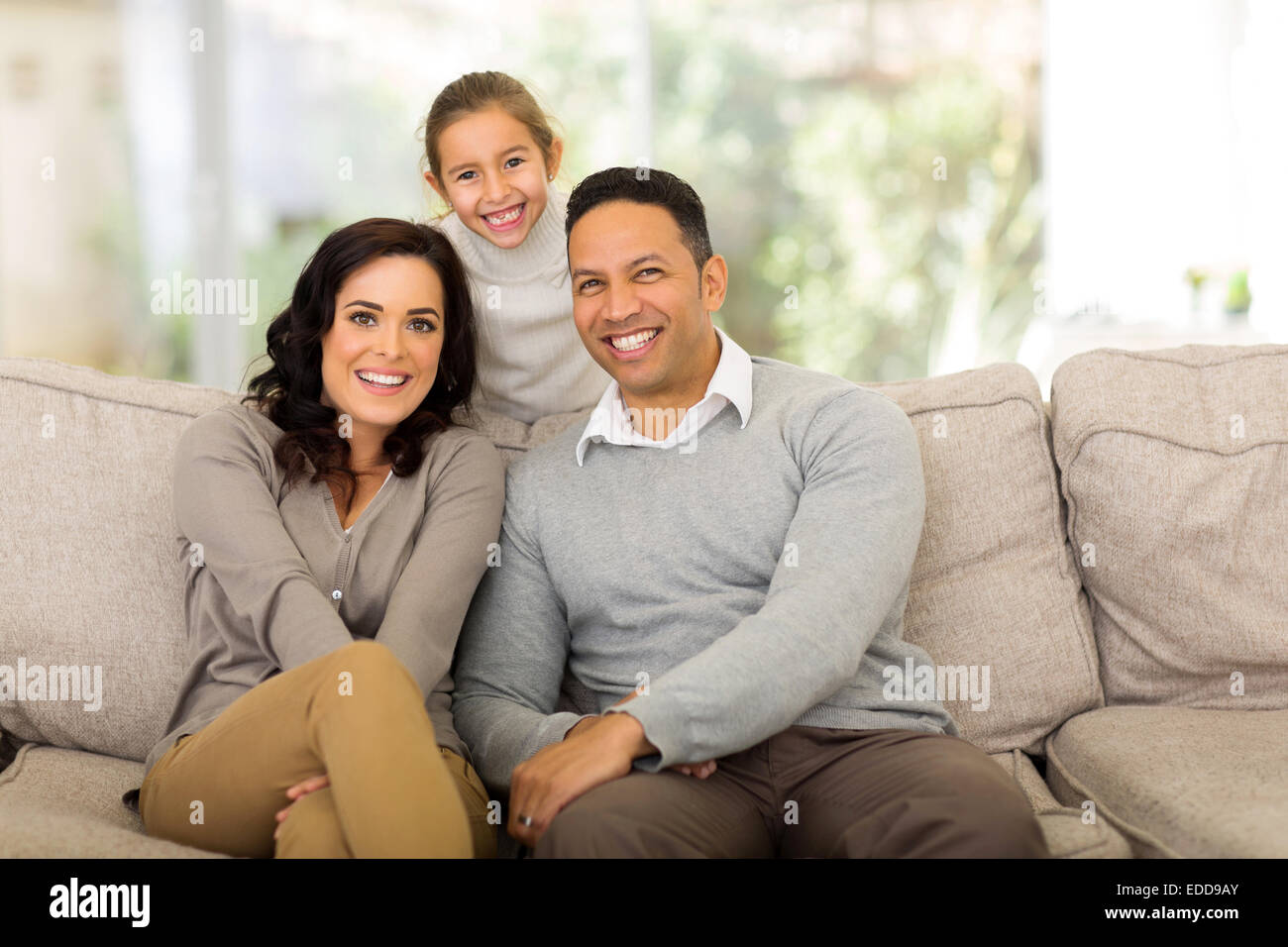 happy family of three relaxing together at home Stock Photo - Alamy
