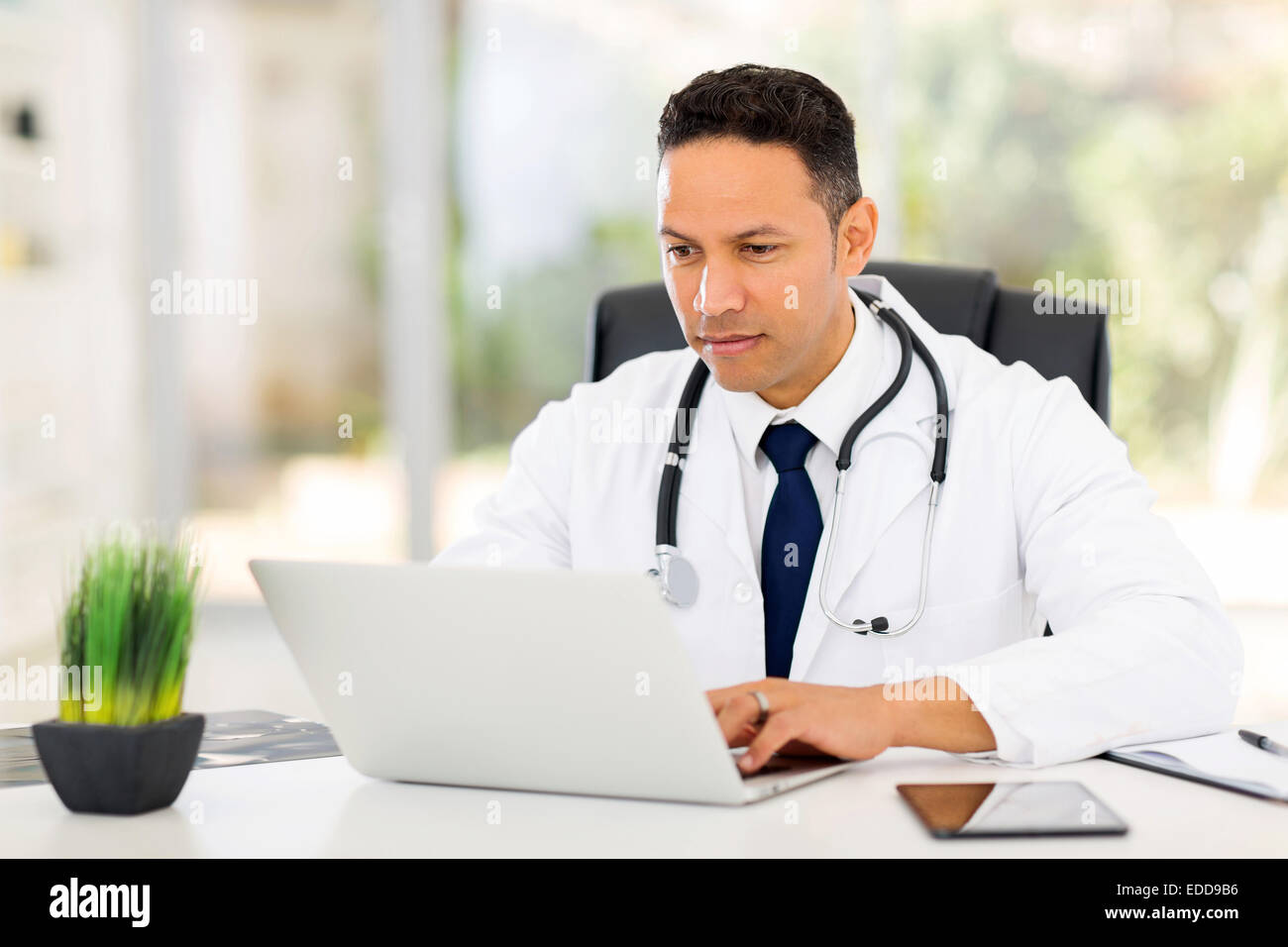 professional mid age medical doctor using laptop in office Stock Photo ...