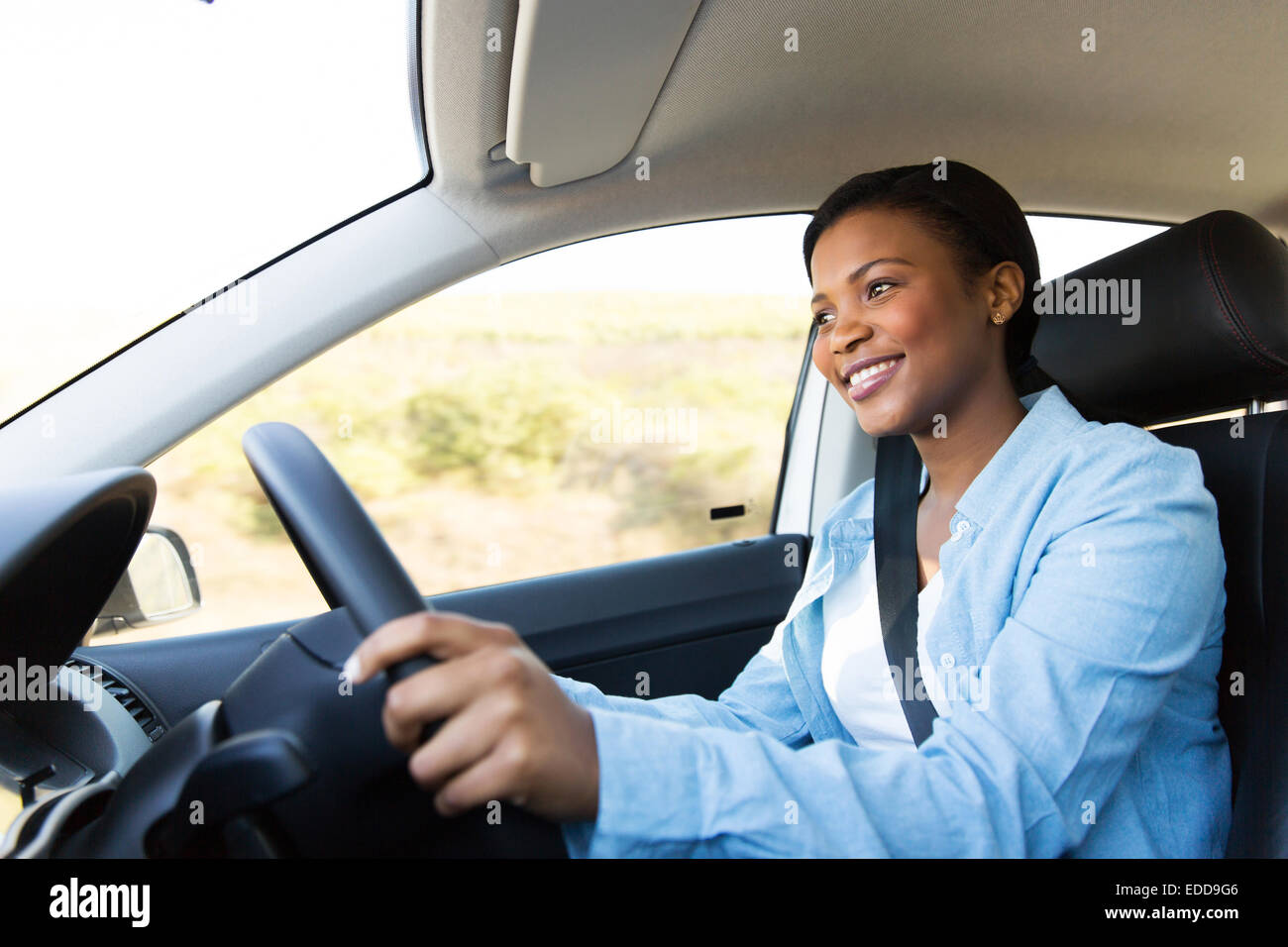 Young black woman driving hi-res stock photography and images - Alamy