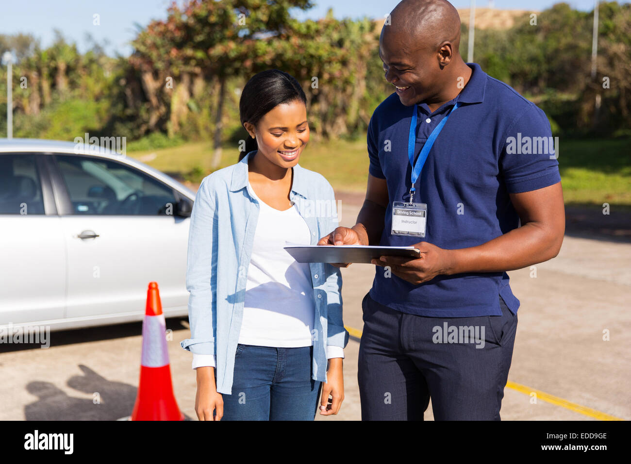 African learner driver with instructor before talking driving test ...