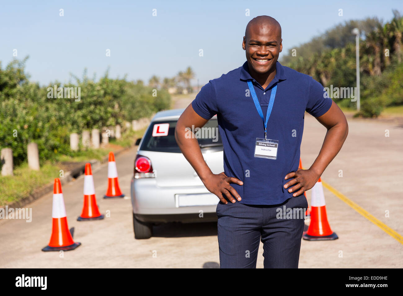 happy African driving instructor standing in testing ground Stock Photo ...