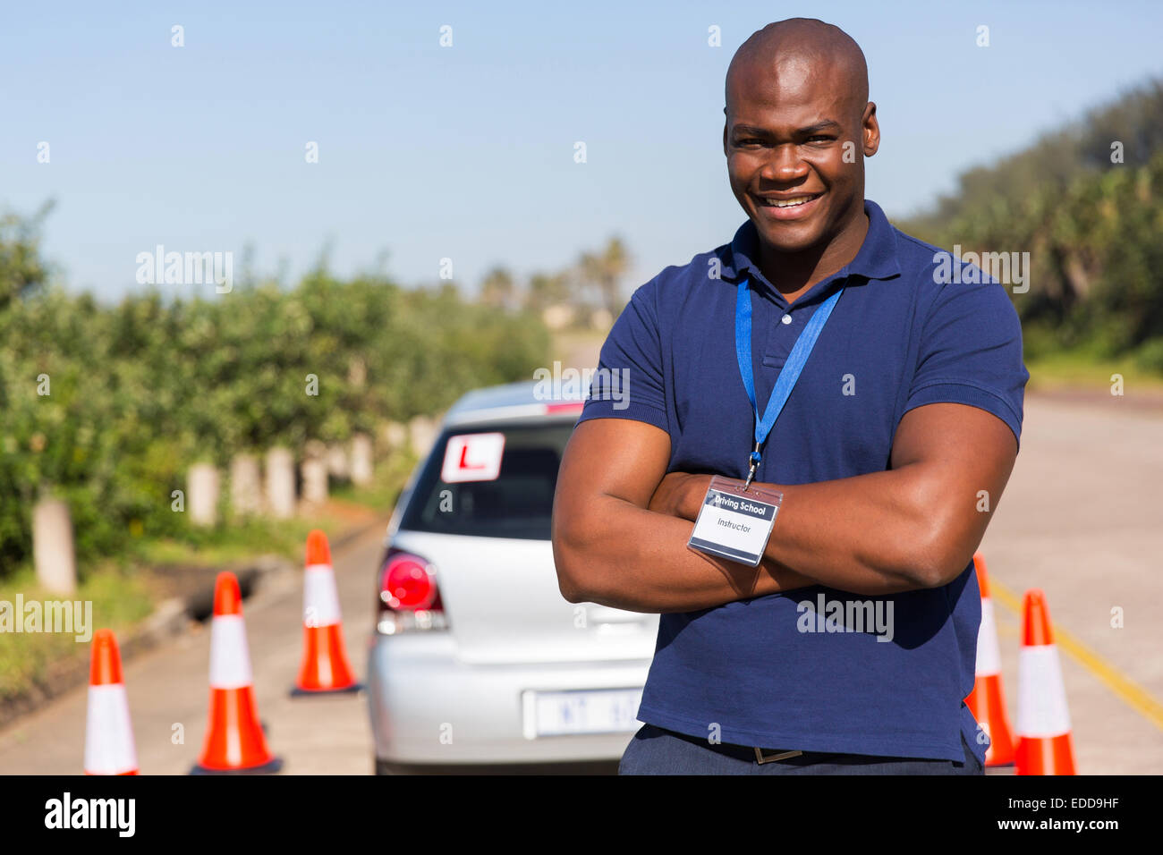 handsome afro American driving instructor with arms crossed Stock Photo ...