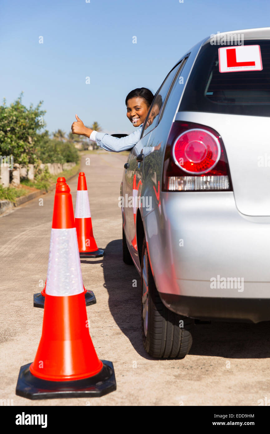 cheerful African student driver giving thumb up Stock Photo - Alamy