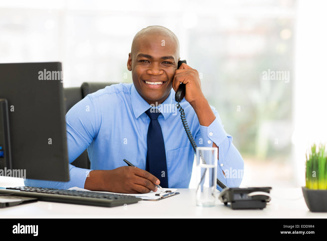 Happy african office male worker hi-res stock photography and images ...
