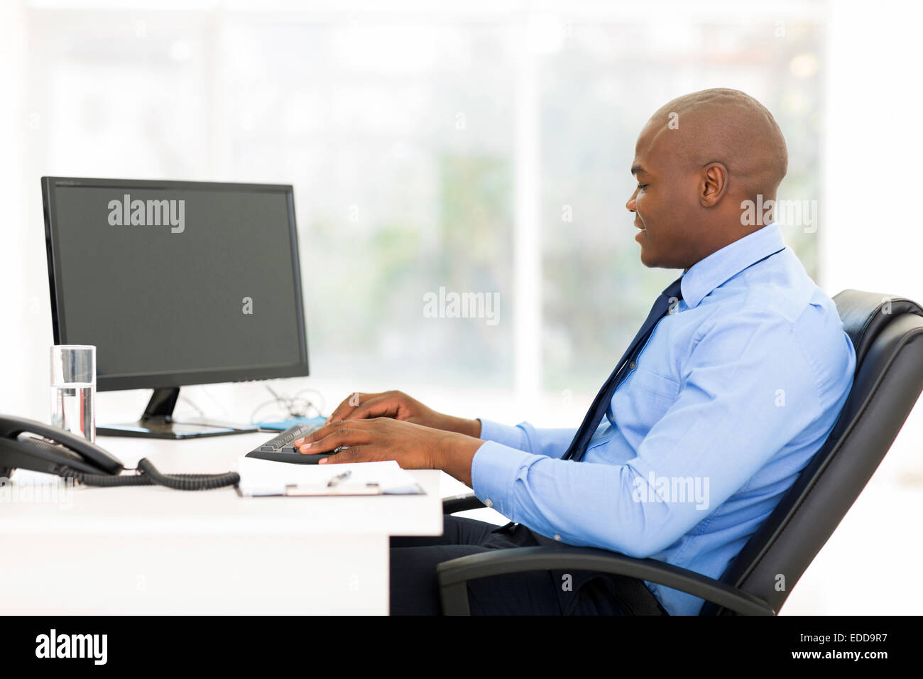 black business man at desk typing on keyboard Stock Photo - Alamy